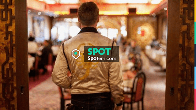 The jacket is white with a scorpion yellow embroidered on the back worn ...