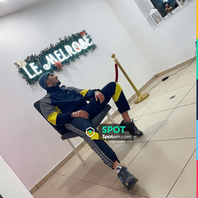 The tracksuit pants Lacoste patchwork blue, yellow and white worn by Lazer MMZ on his account ...