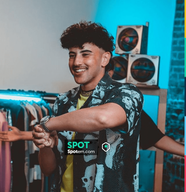 The black shirt has patterns of white faces worn by Just Riadh on his ...