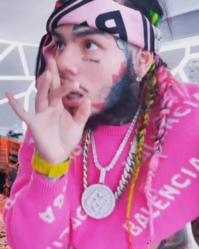 The pink monogrammed Balenciaga sweater worn by 6ix9ine on his ...