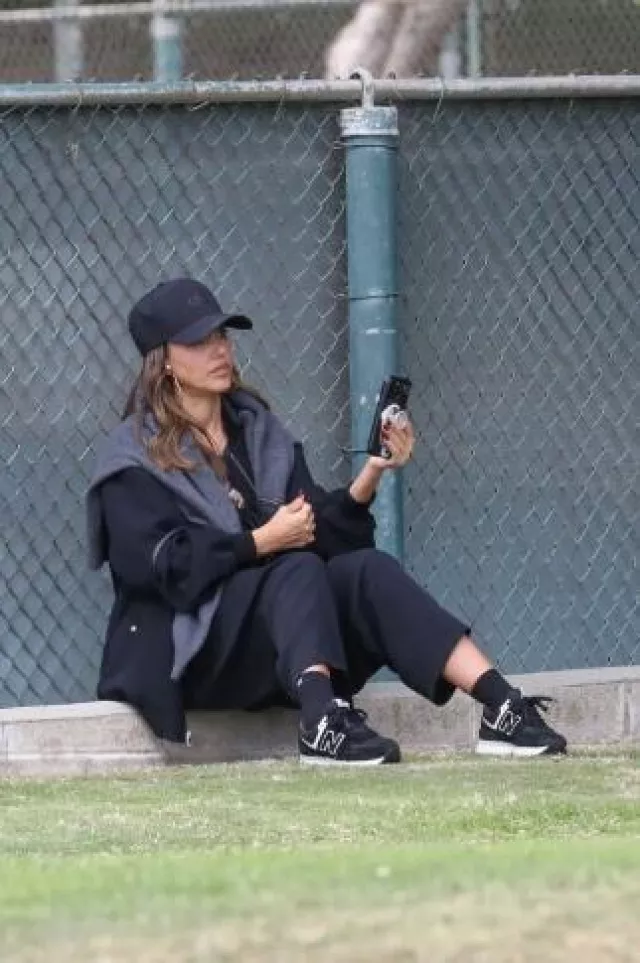 Alo Yoga Performance District Trucker Hat worn by Jessica Alba in Santa ...