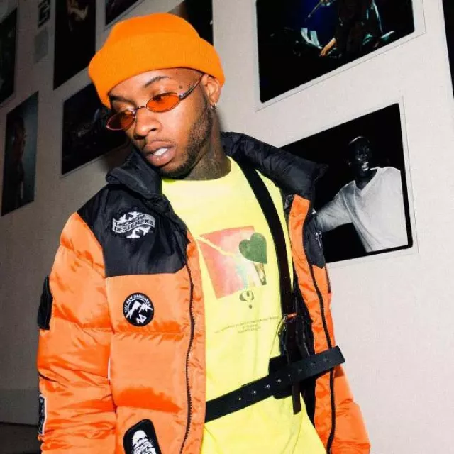 The New Designers Orange Patches Puffer Jacket worn by Tory Lanez on ...