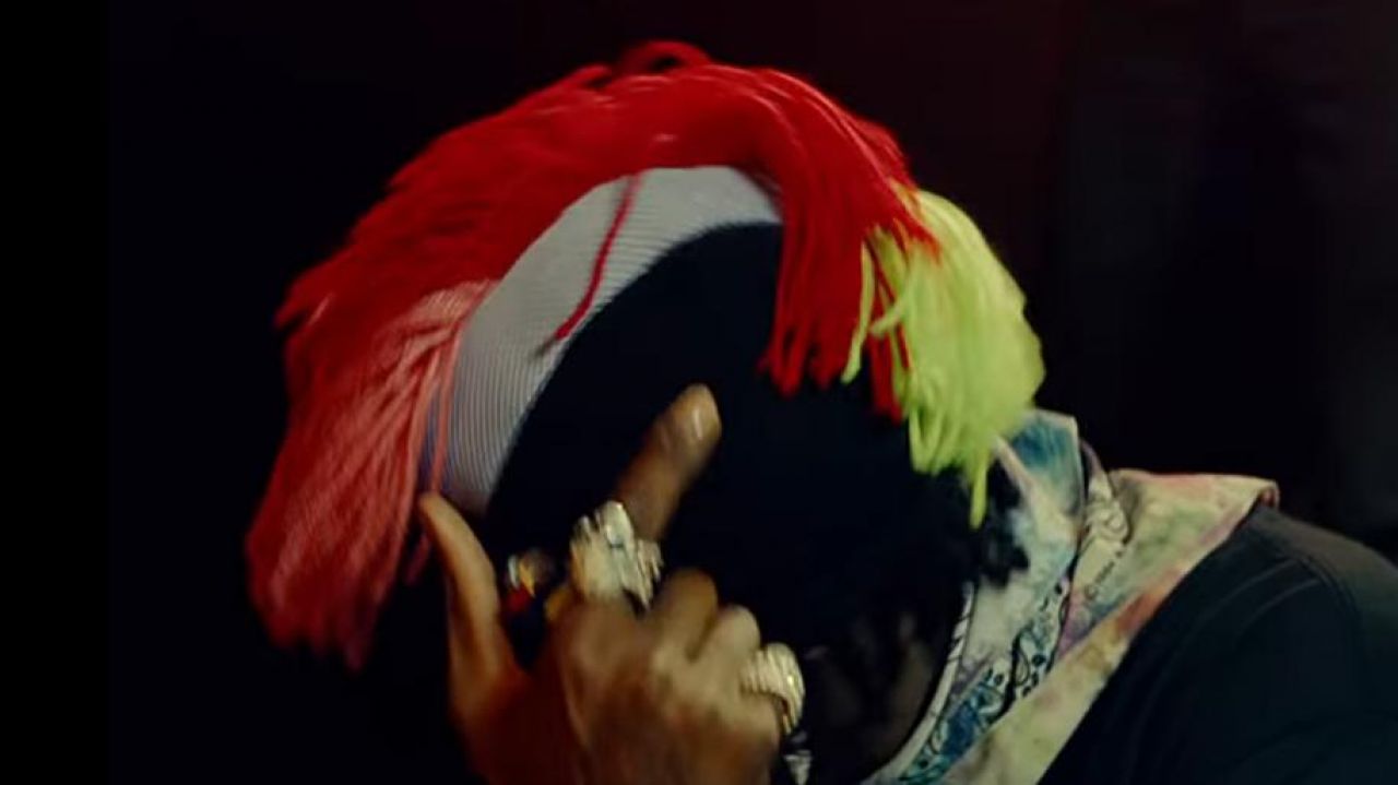 Red an yellow winter hat worn by Playboi Carti in Get Dripped music ...