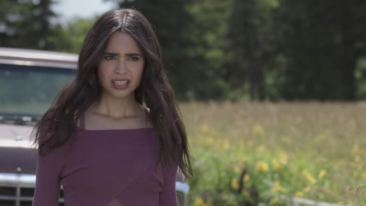 Shoulder off crossed top worn by April Dibrina (Sofia Carson) in Feel ...