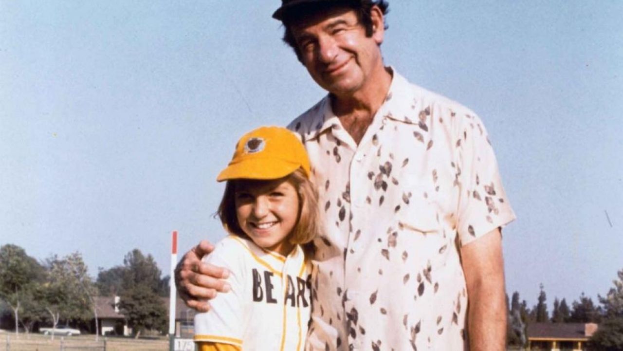 Small black leaves on white button short sleeve shirt worn by Coach ...