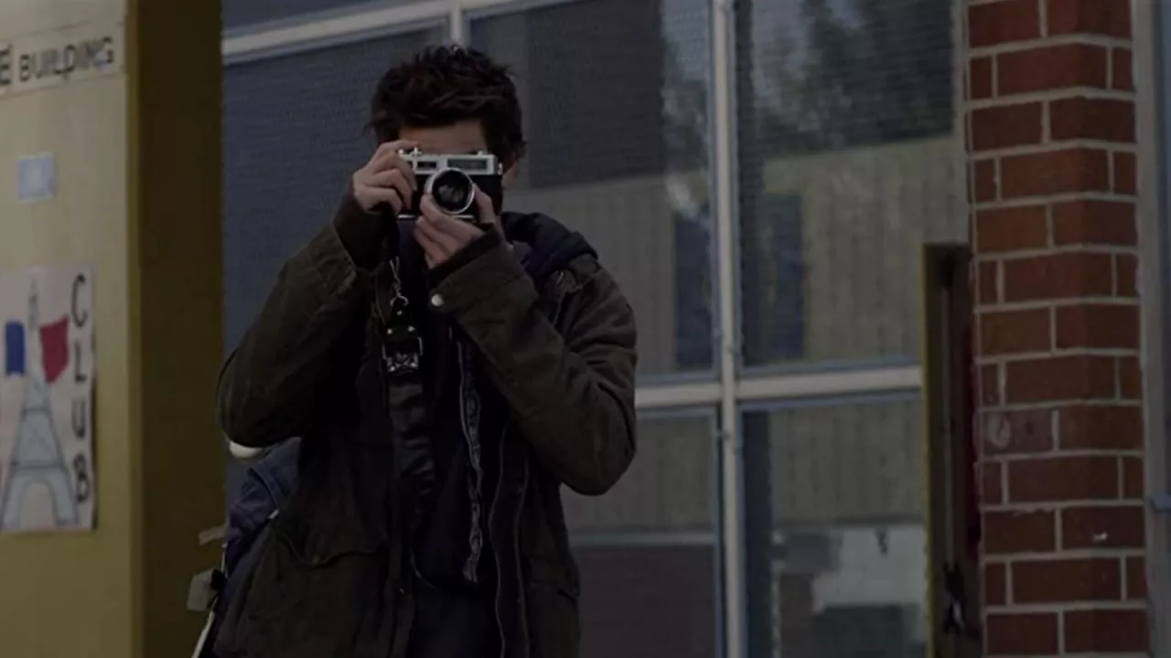 The strap of the camera used by Peter Parker (Andrew Garfield) in the ...