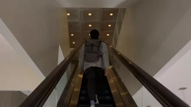 Grey backpack worn by Alejandro (Julio Torres) as seen in Problemista ...